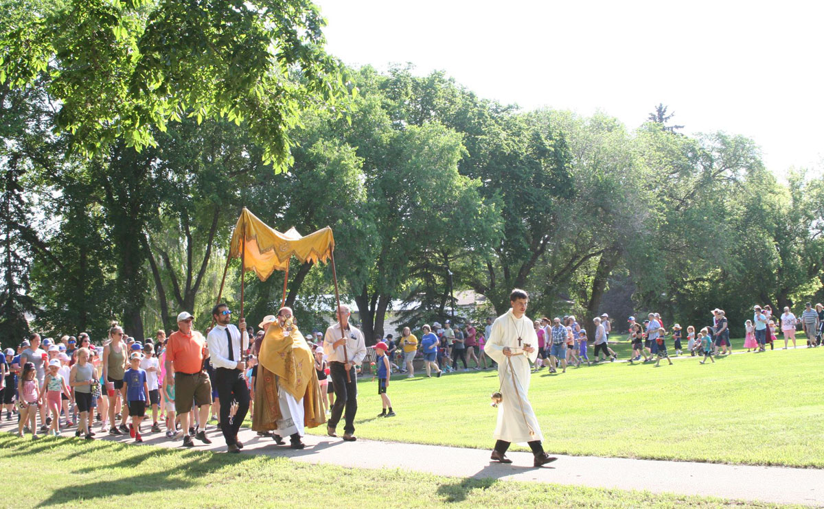 Children join in procession bringing Jesus into the street in Unity, SK ...